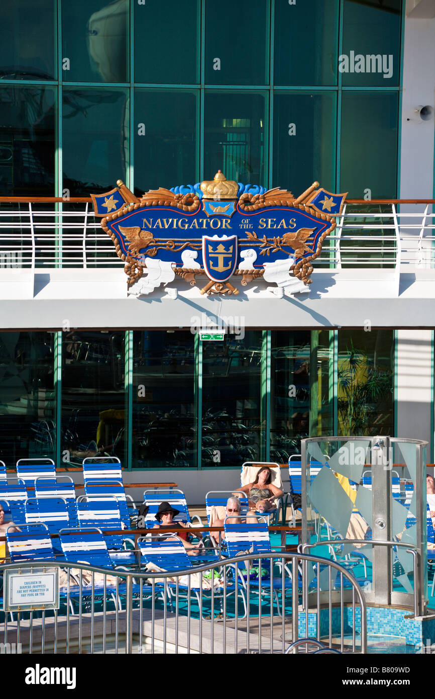 Navigator of the Seas sign above sunbathers onboard cruise ship Stock ...