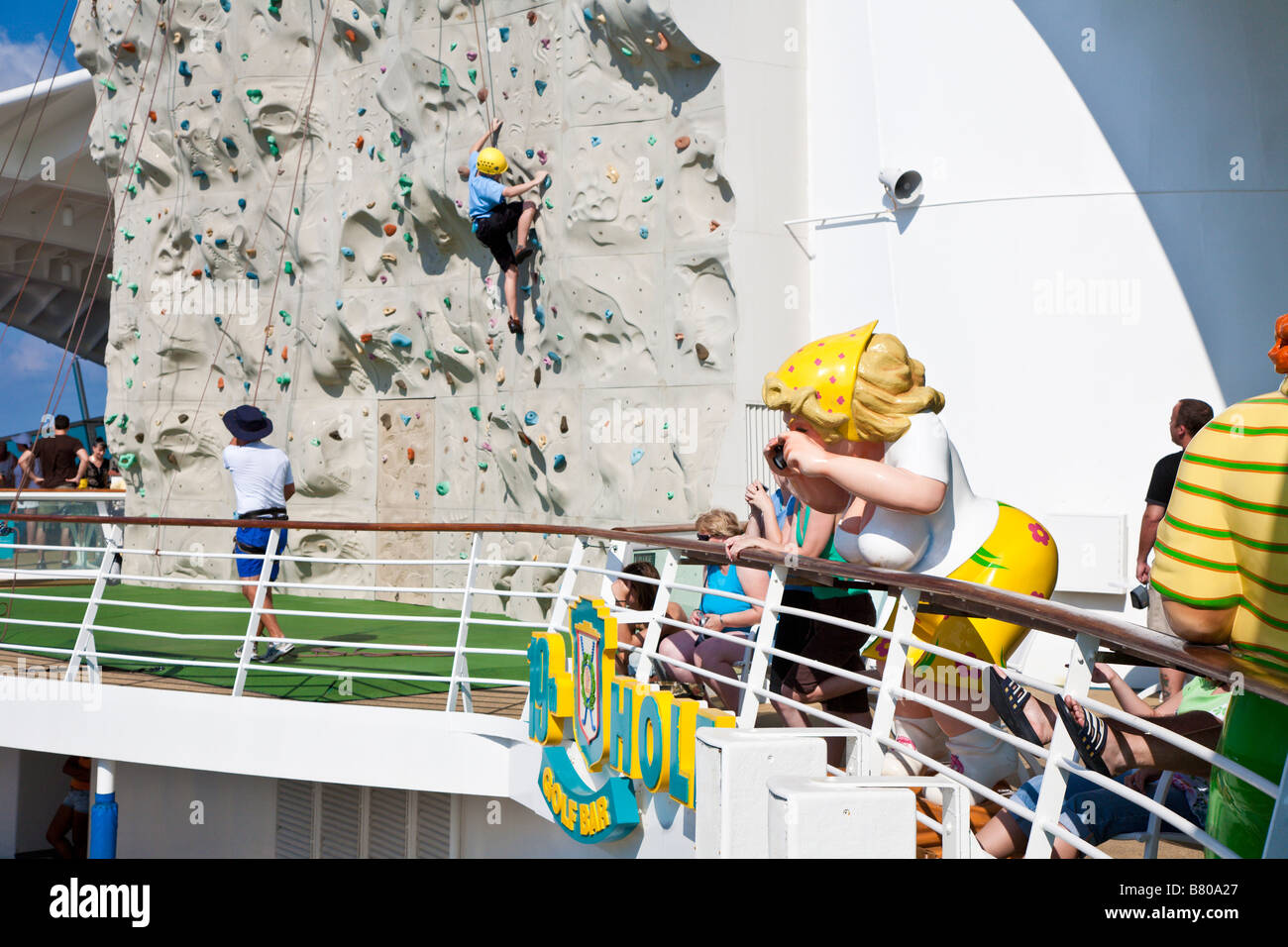 Cruise passenger climbing artificial rock wall onboard Royal Caribbean ...