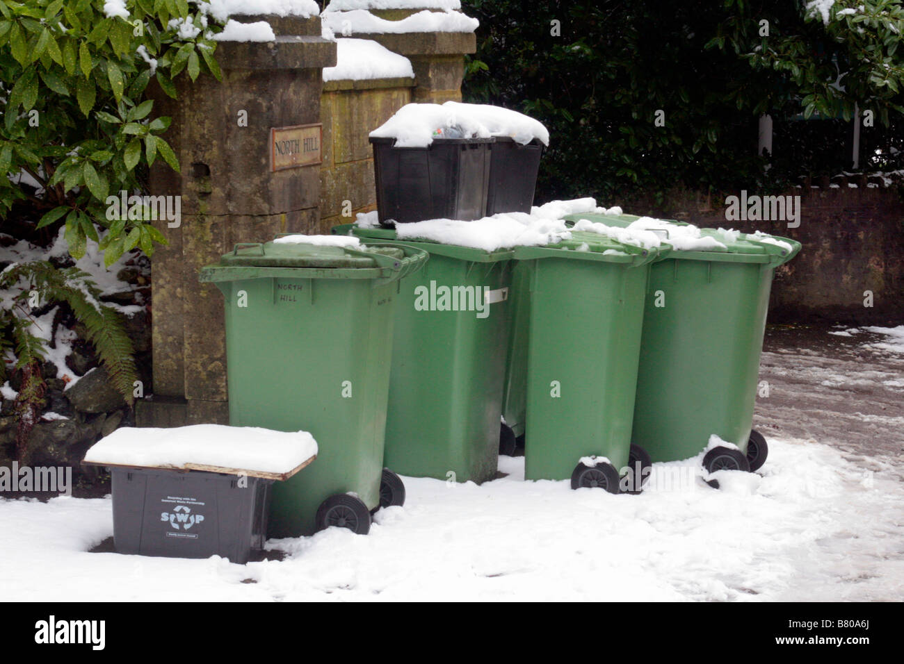 Green recycling bins awaiting collection on a cold winters day Stock ...