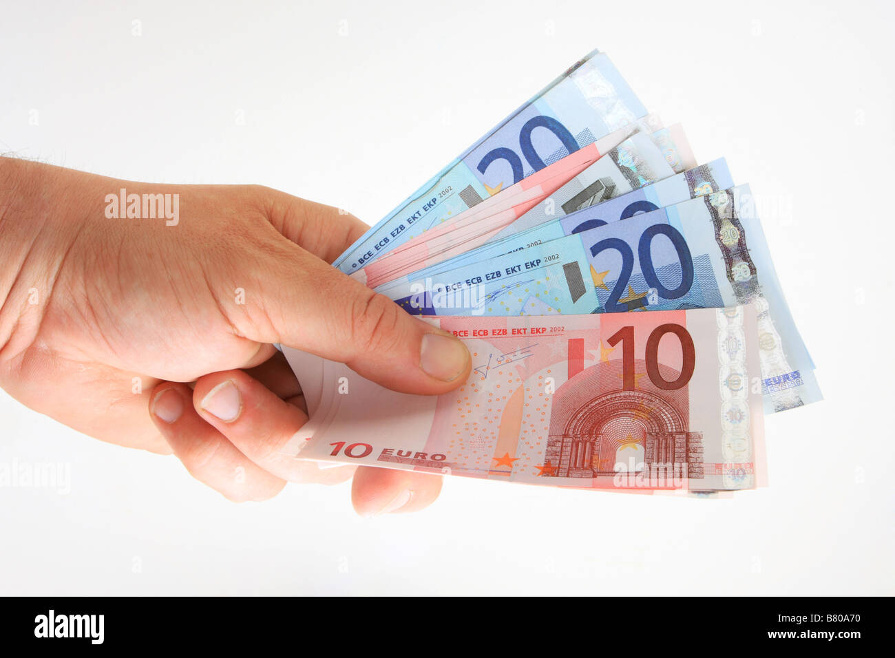 Caucasian hand holding a wad of euros for payment isolated on white ...