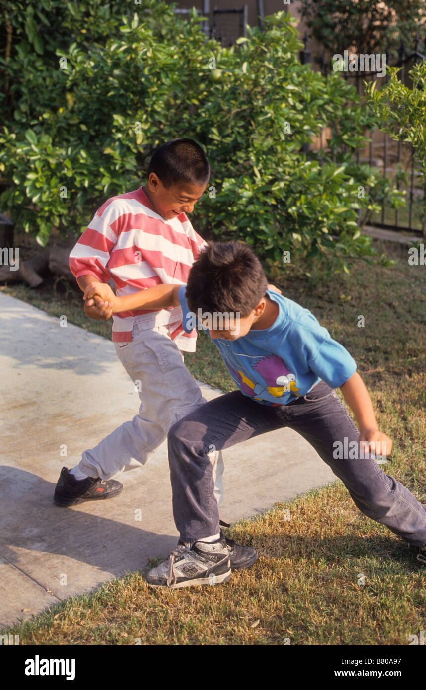 Two boys "Indian wrestle" outdoors Stock Photo - Alamy