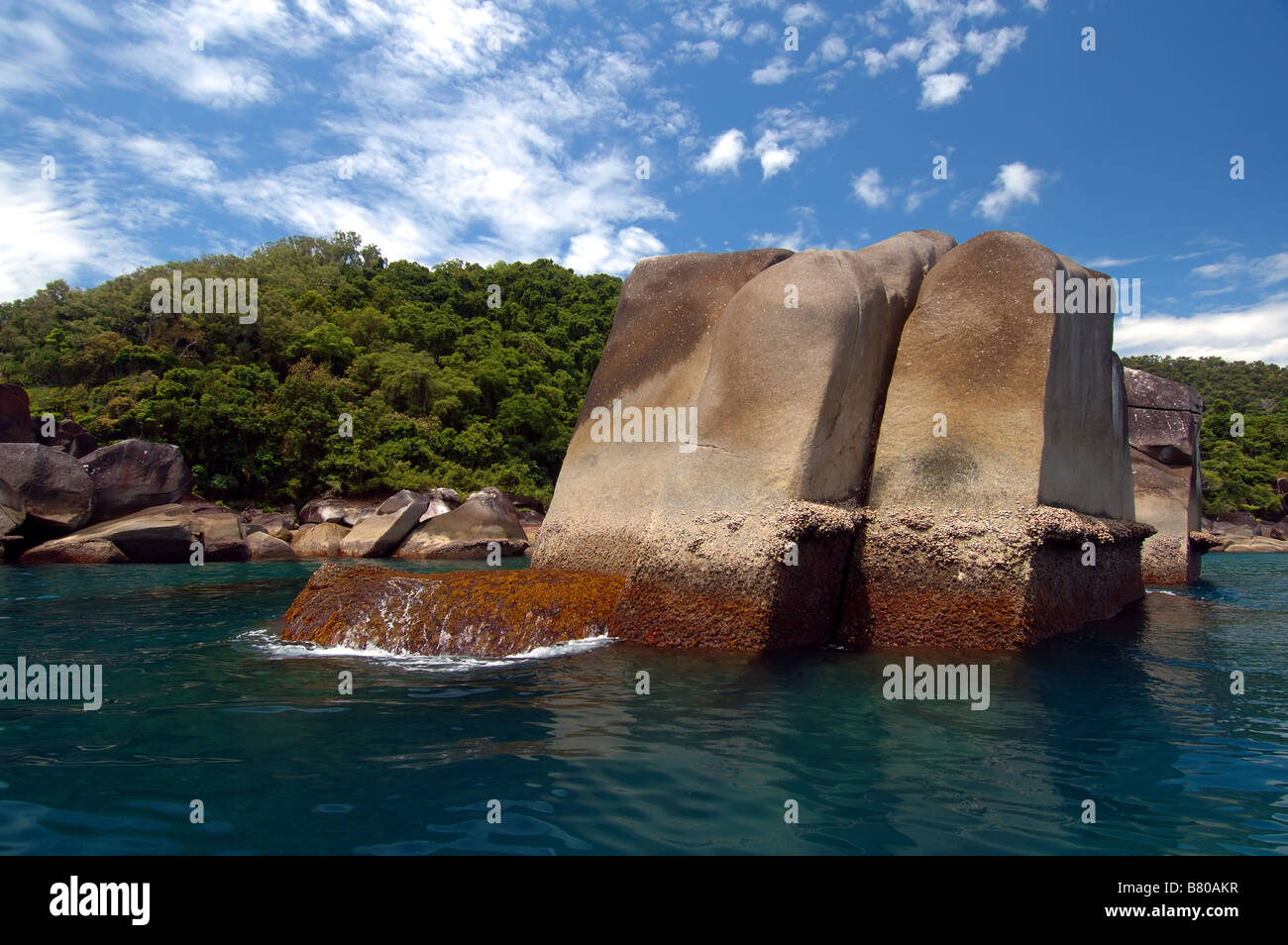 Rocky coastline and rainforested slopes of Dunk Island, on the Great ...