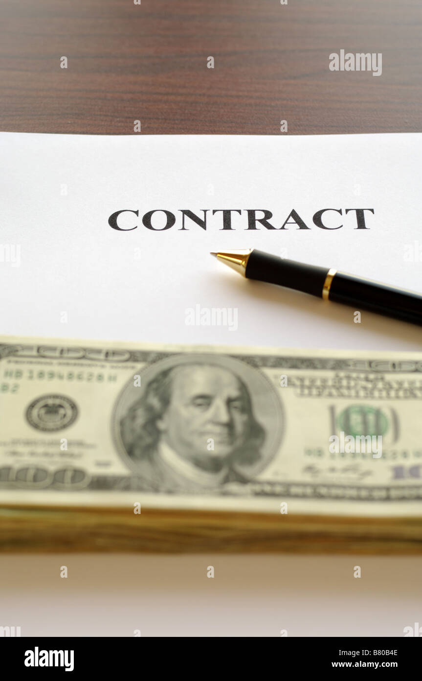 Contract document with pen and stack of dollars Stock Photo - Alamy