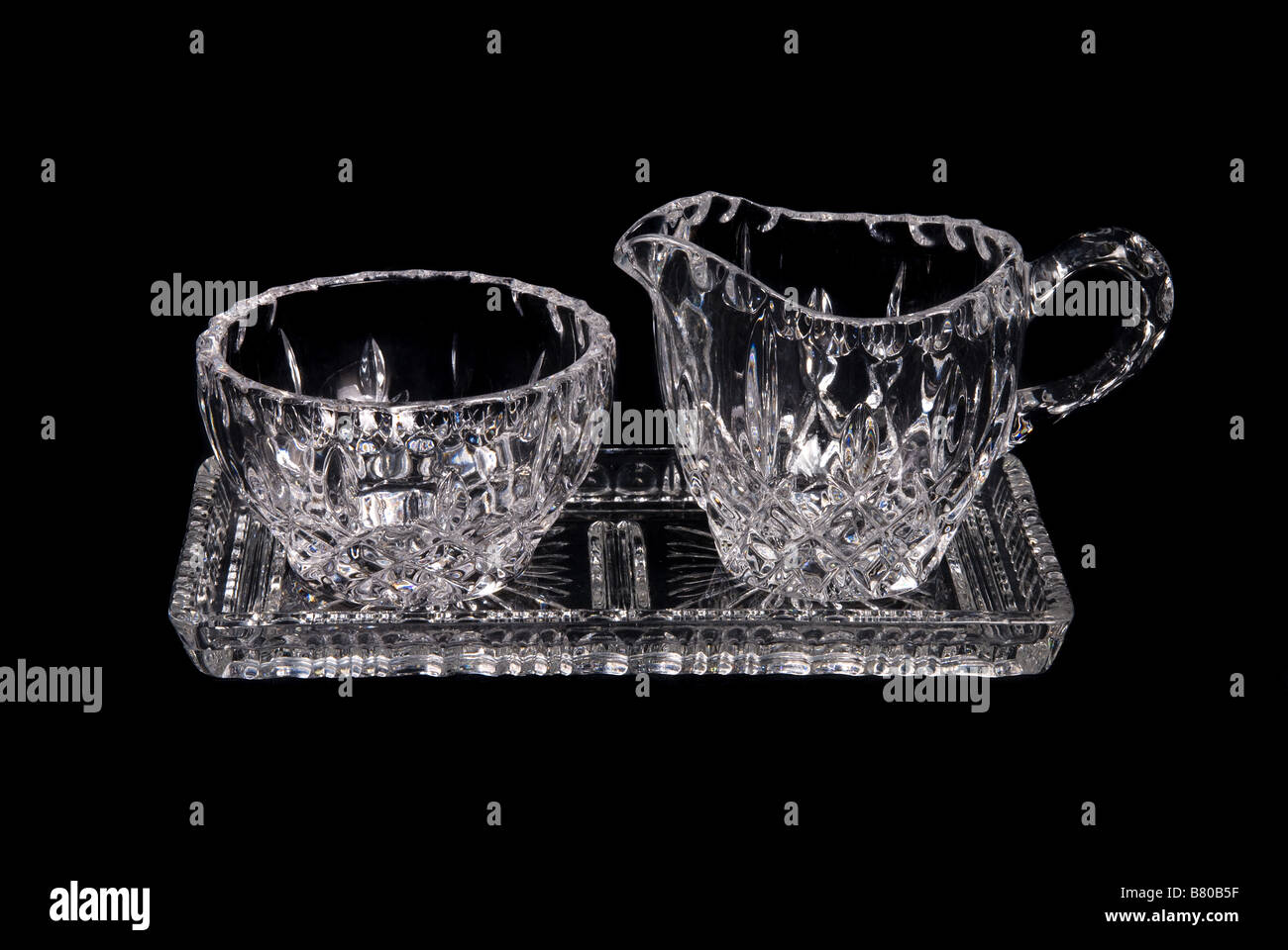 Crystal serving dishes for sugar and cream isolated on black Stock ...