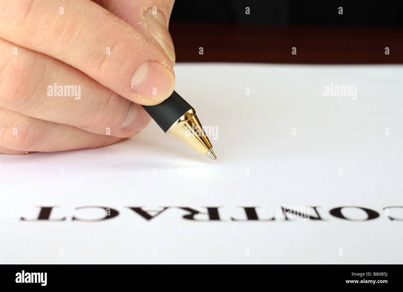 Hand signing on a contract Stock Photo - Alamy