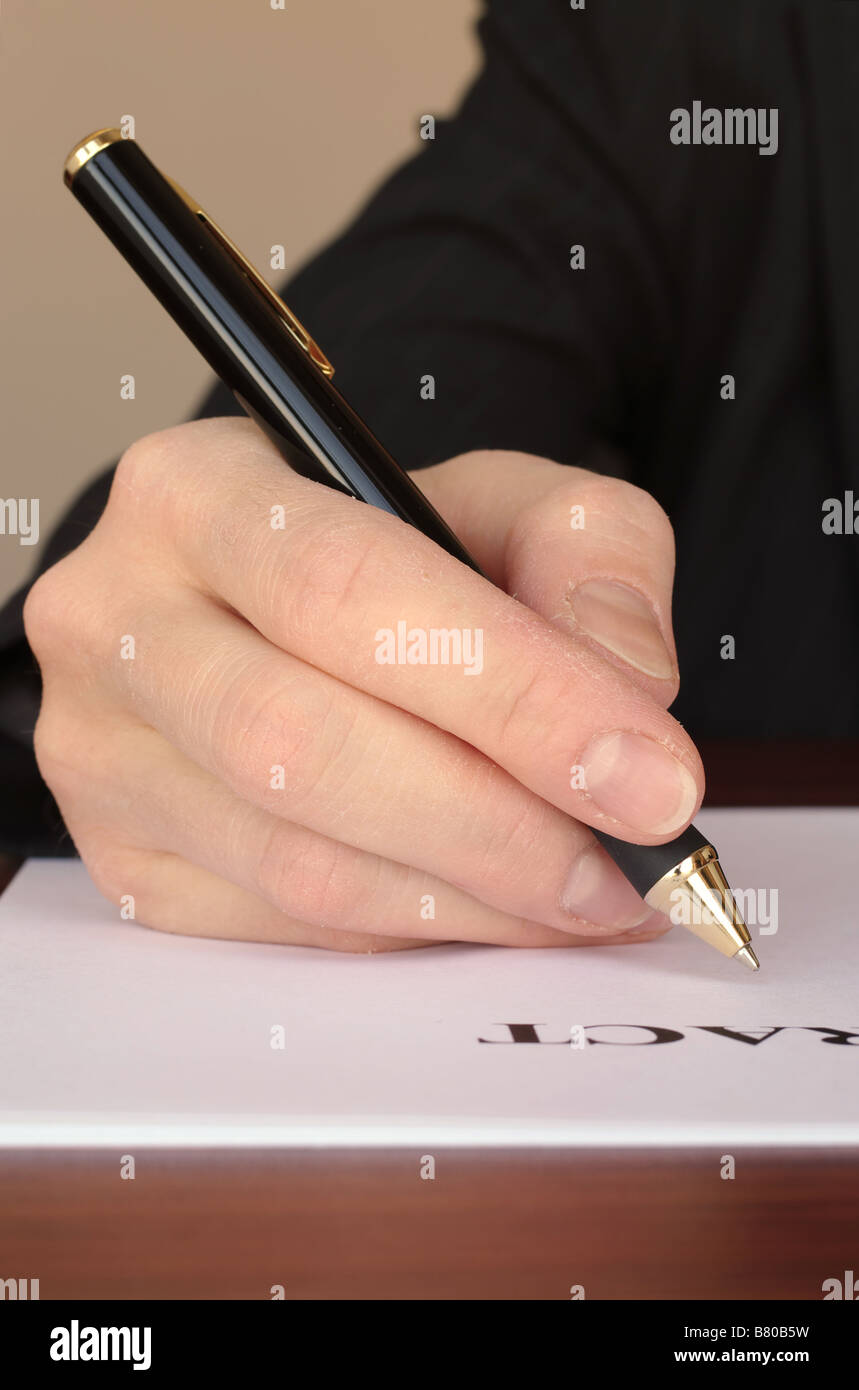 Hand signing on a contract Stock Photo - Alamy