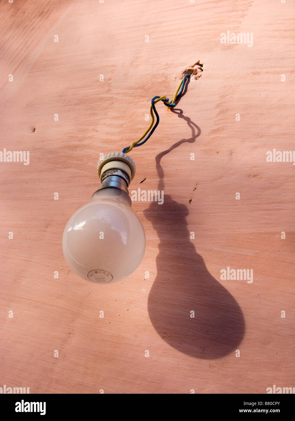 Light bulb against wall Stock Photo - Alamy