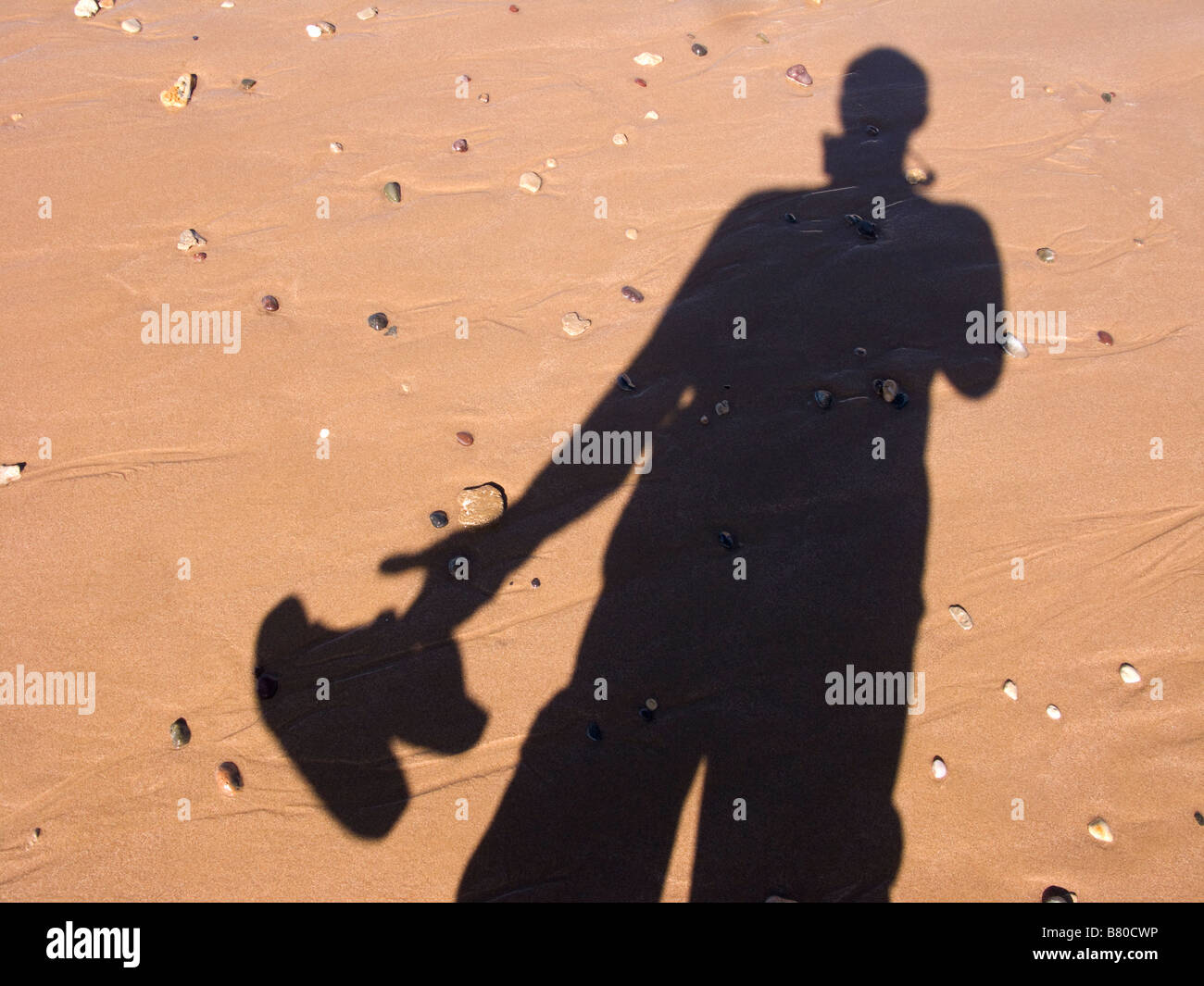 Shadow of person on beach sand Stock Photo - Alamy