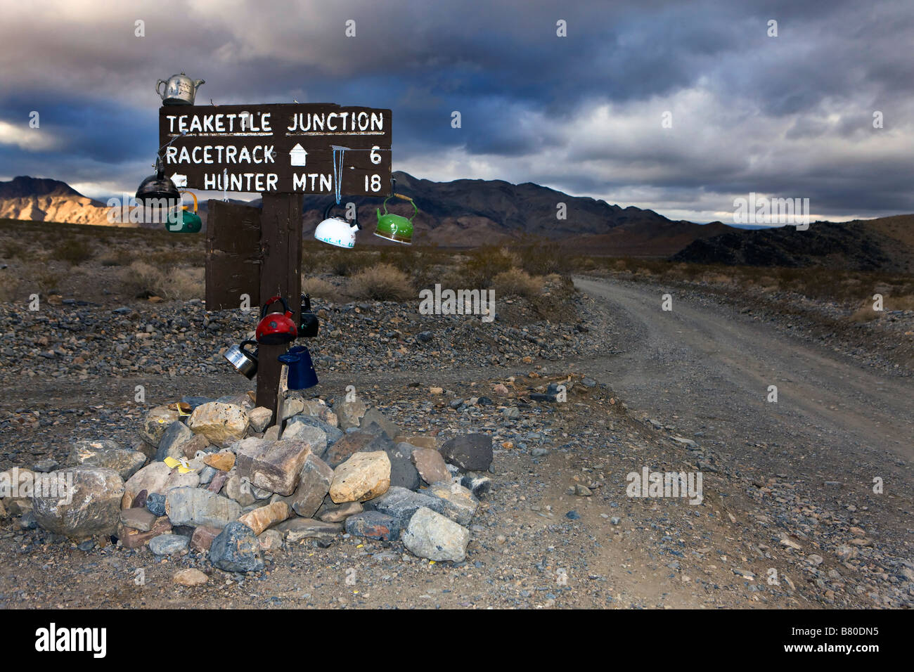 Tea pots hang from mileage signs at Teakettle Junction near the ...