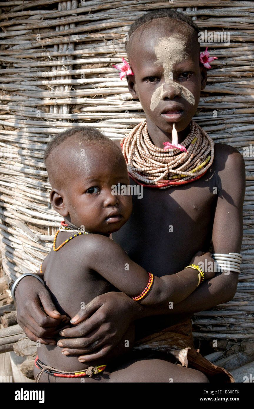 Young Karo girl with little boy in her arms Omovalley Ethiopia Africa ...
