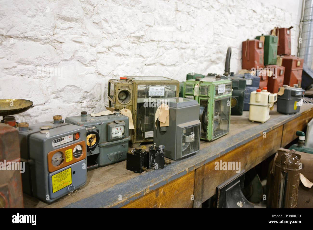 Collection of gas meters from mid 1800s through to 1970s on a bench in ...