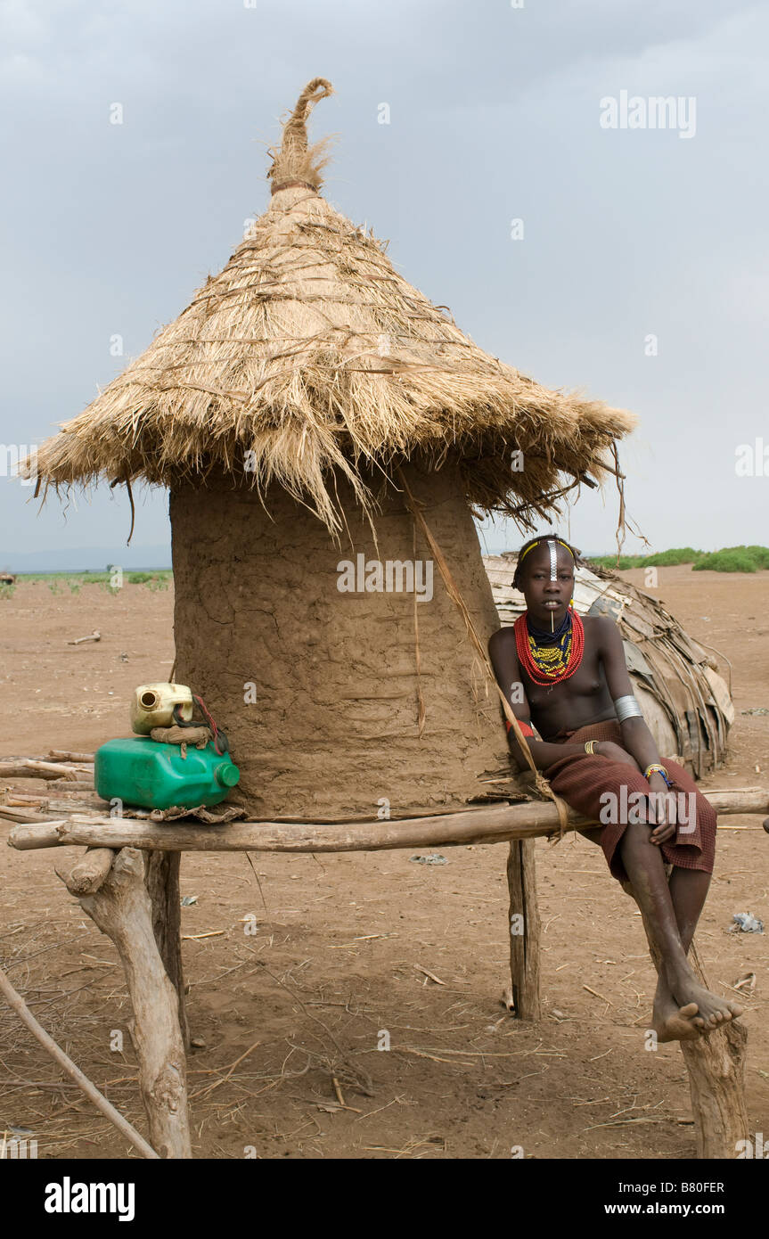 Dasanach tribal person sitting on a wheat cottage Oromote Ethiopia ...
