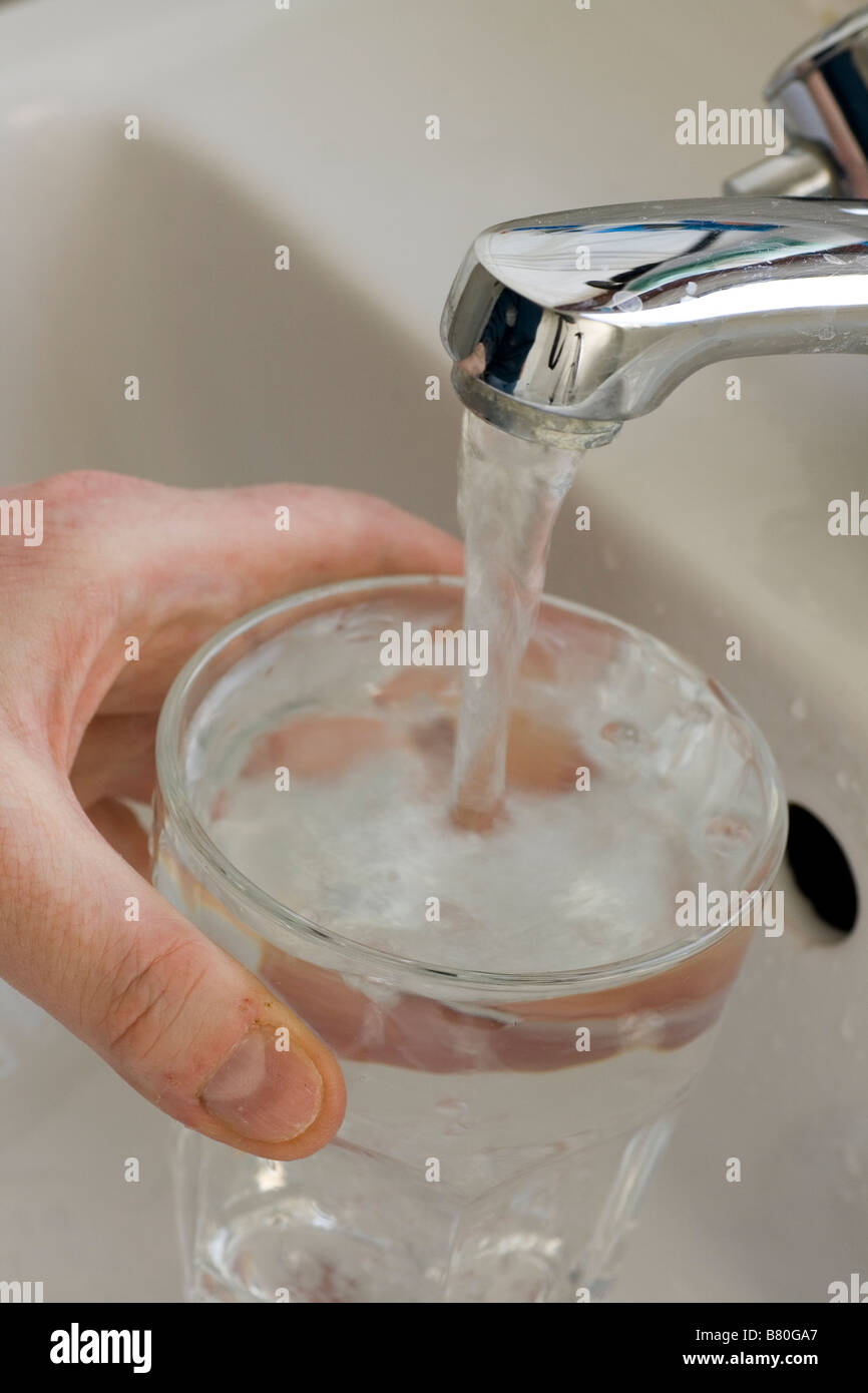 Filling a glass of water Stock Photo - Alamy
