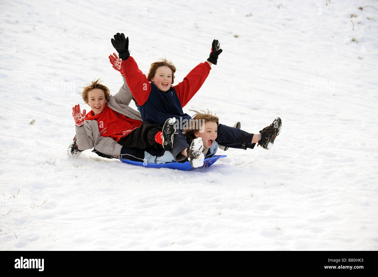 Snow sledging children hi-res stock photography and images - Alamy