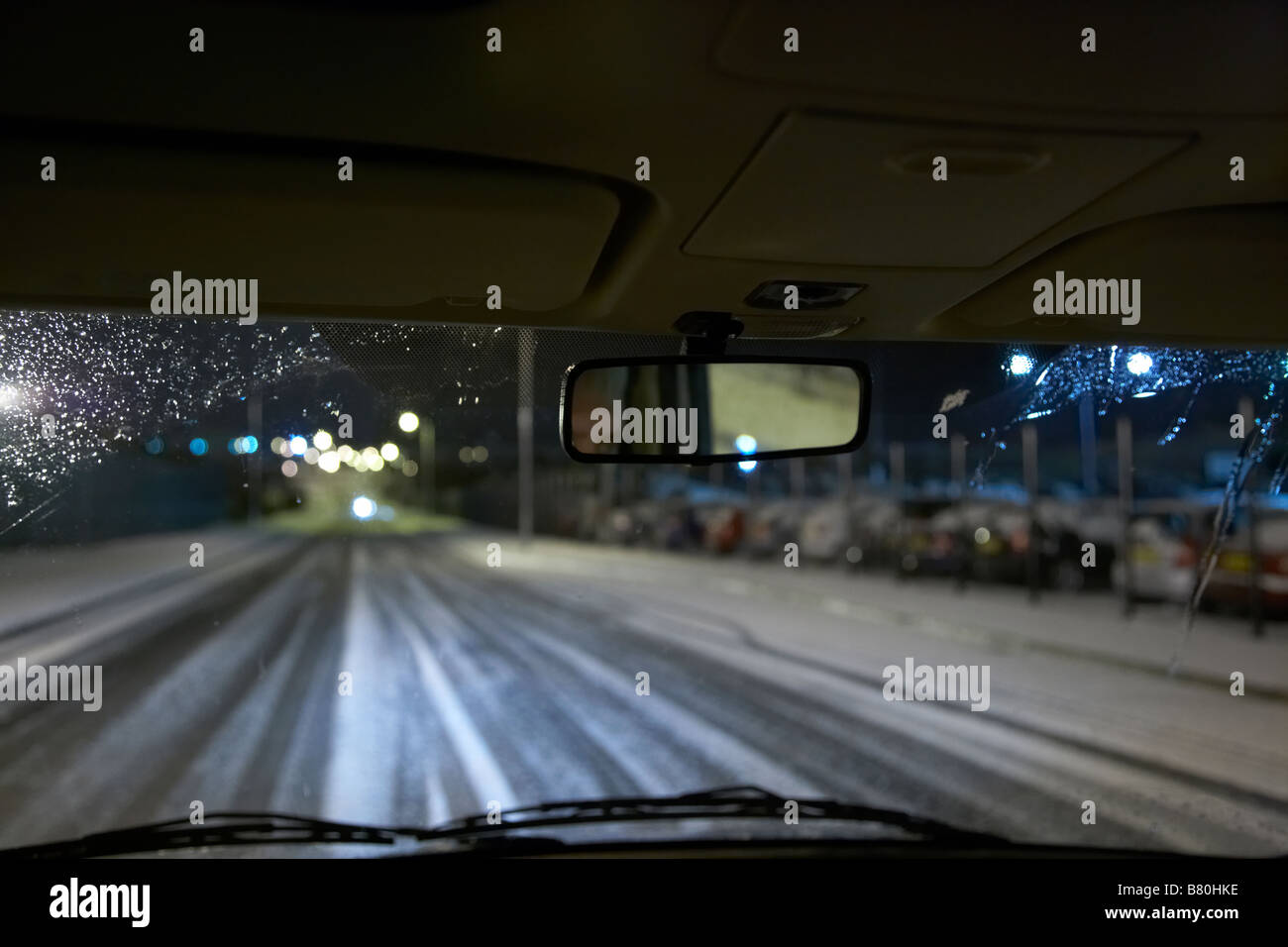 car driving along empty snow covered road at night in the uk Stock ...