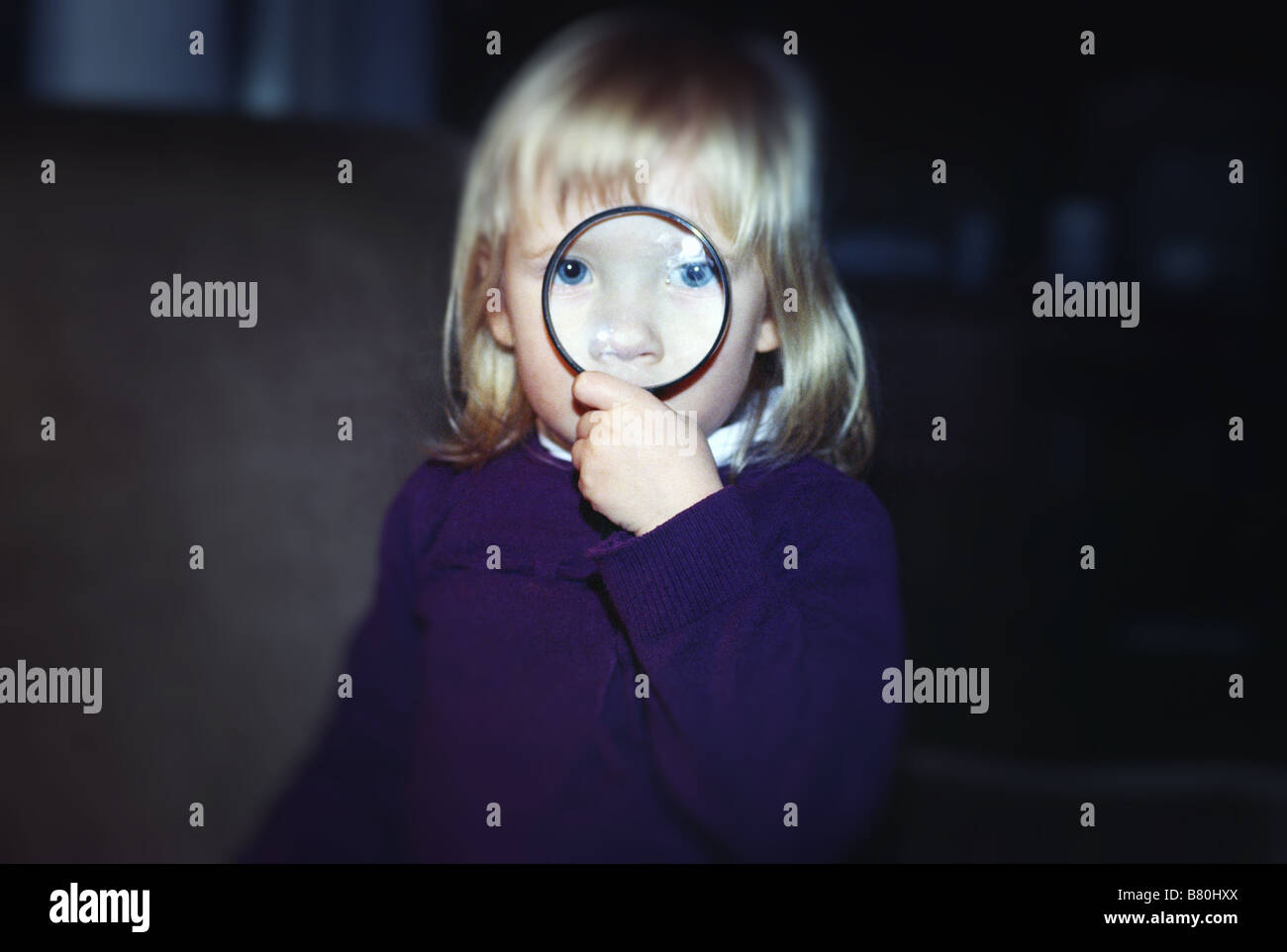 Toddler girl with magnifying glass Stock Photo - Alamy