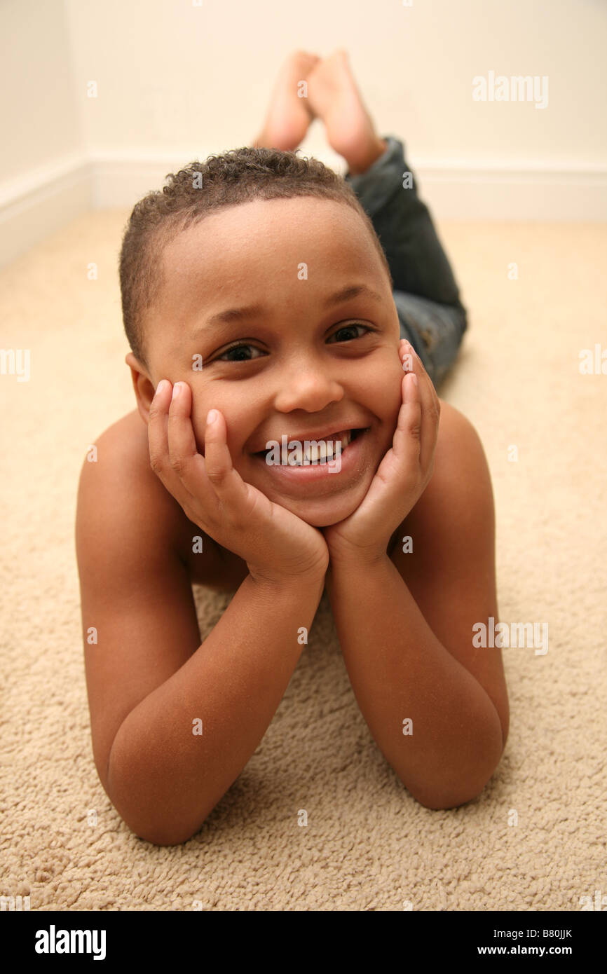 Cheeky Afro caribbean boy smiling Stock Photo - Alamy