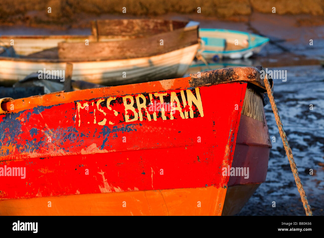Bright coloured boat at low tide, Morston Quay, Norfolk, UK Stock Photo ...