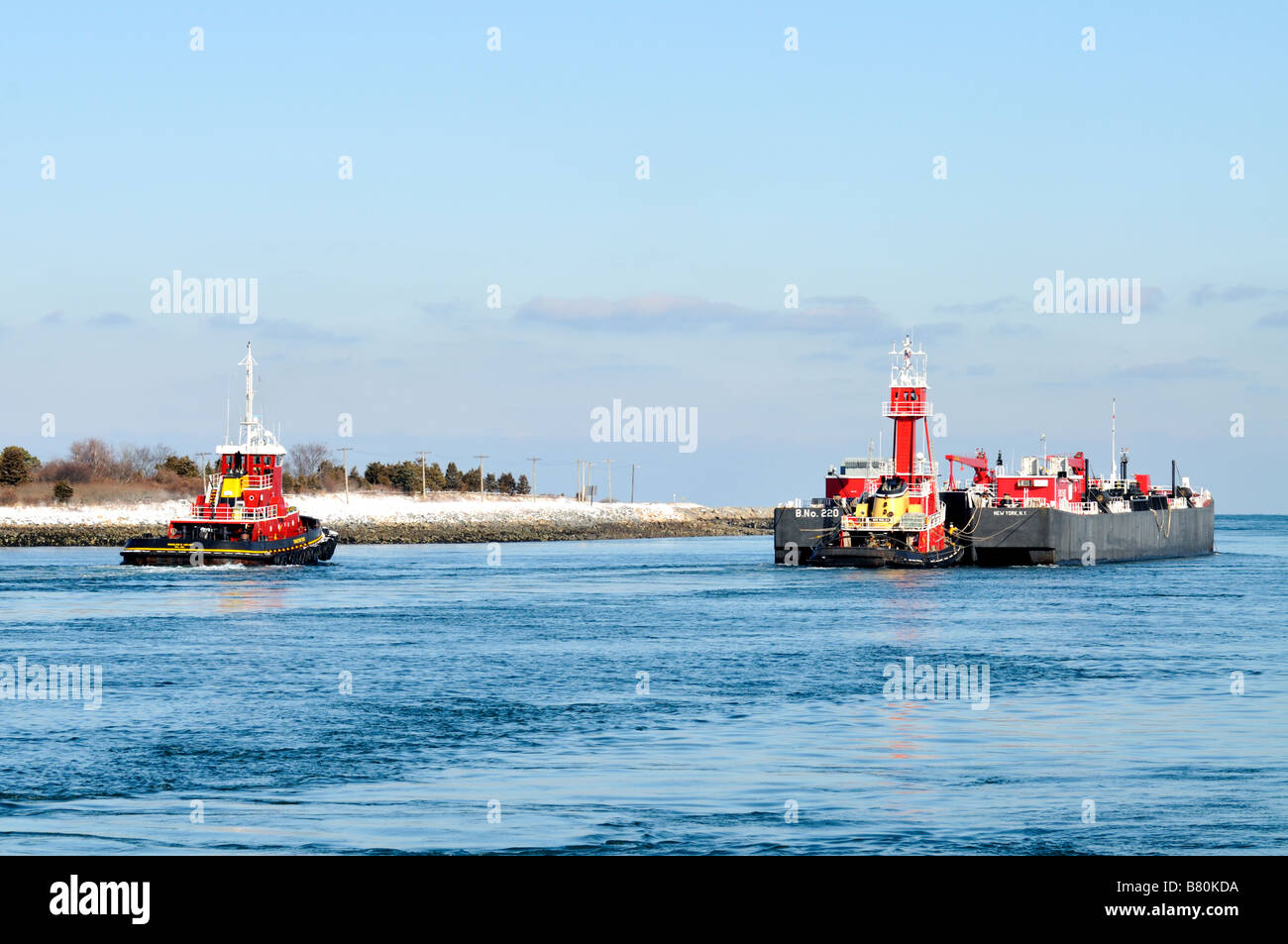 2 tugboats and a barge heading out to sea 1 tug pushing the barge the ...