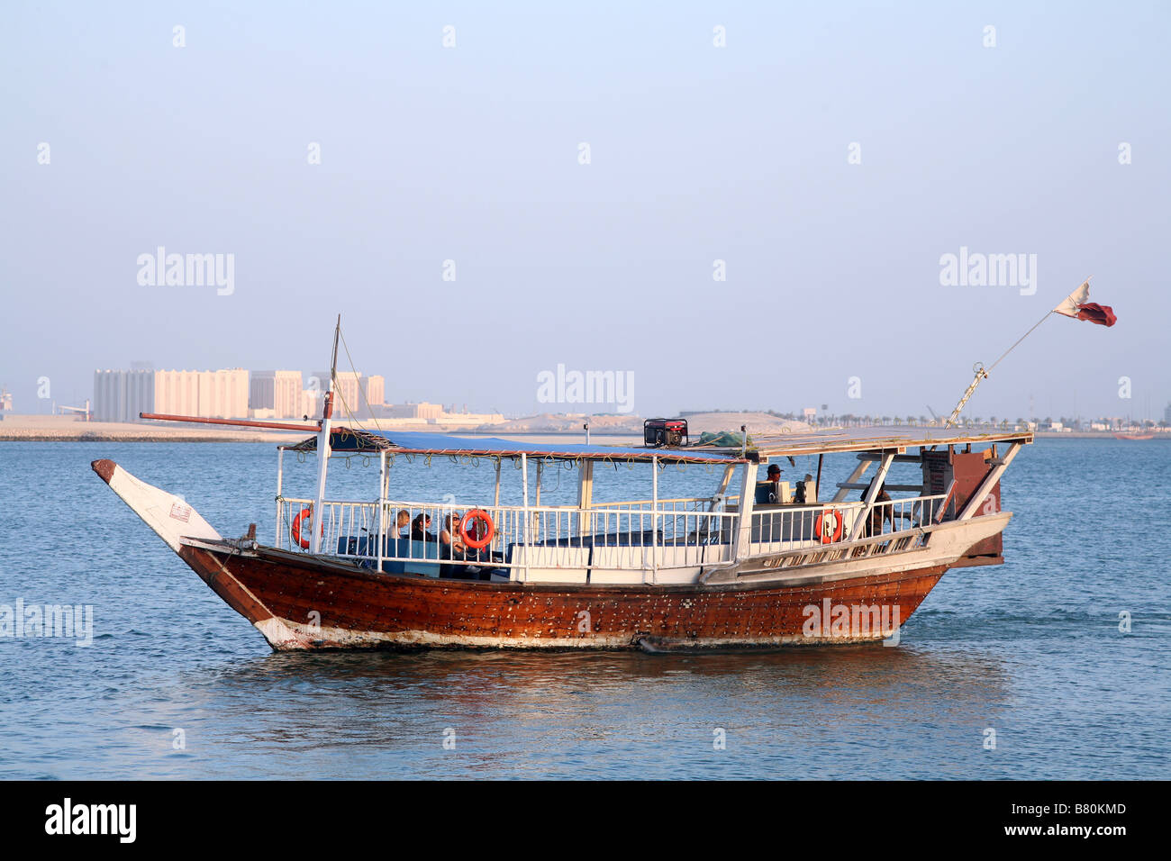 A small dhow takes visitors to Doha Qatar around Doha Bay on a pleasure ...