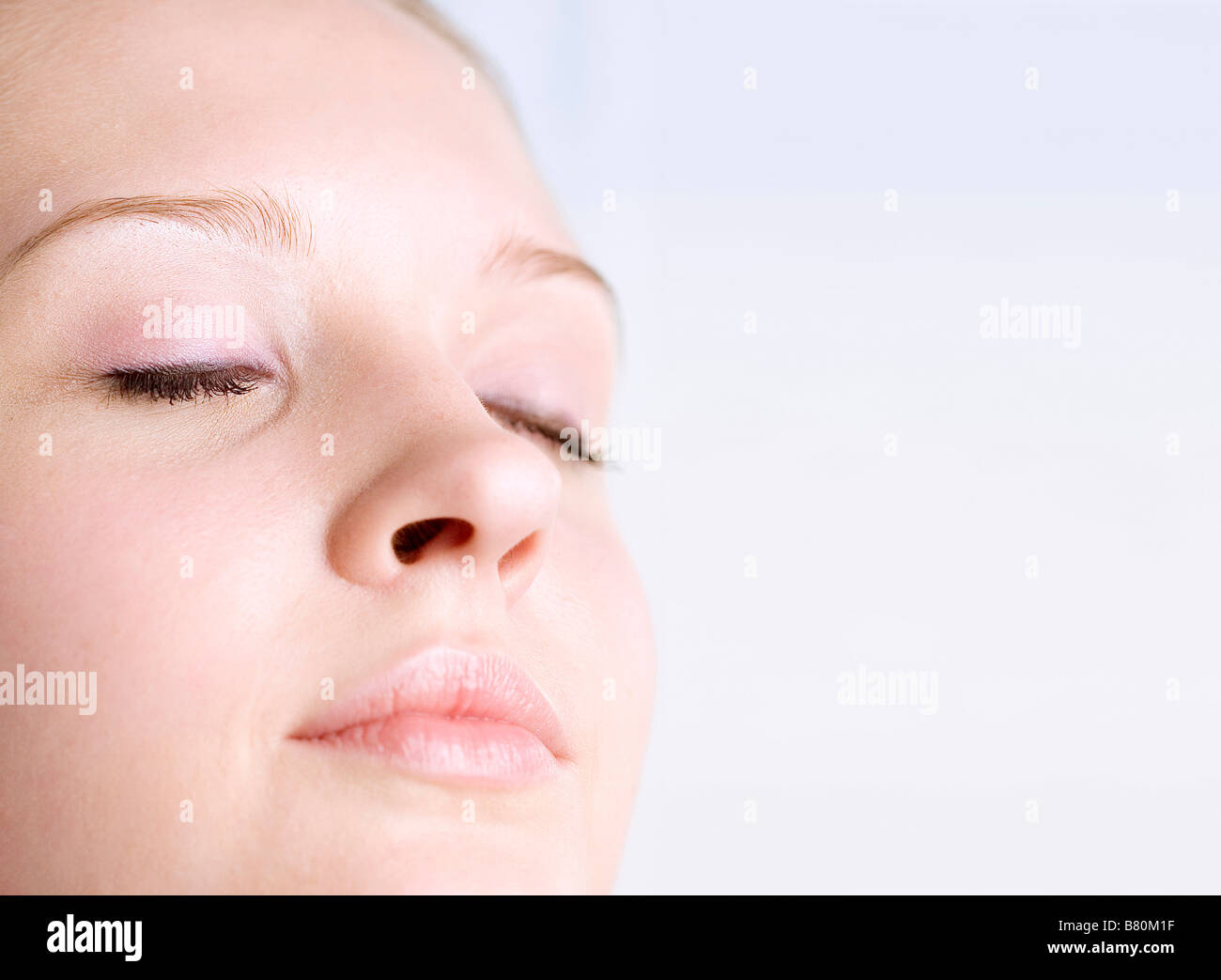 Close up to a young woman s face eyes closed Stock Photo - Alamy