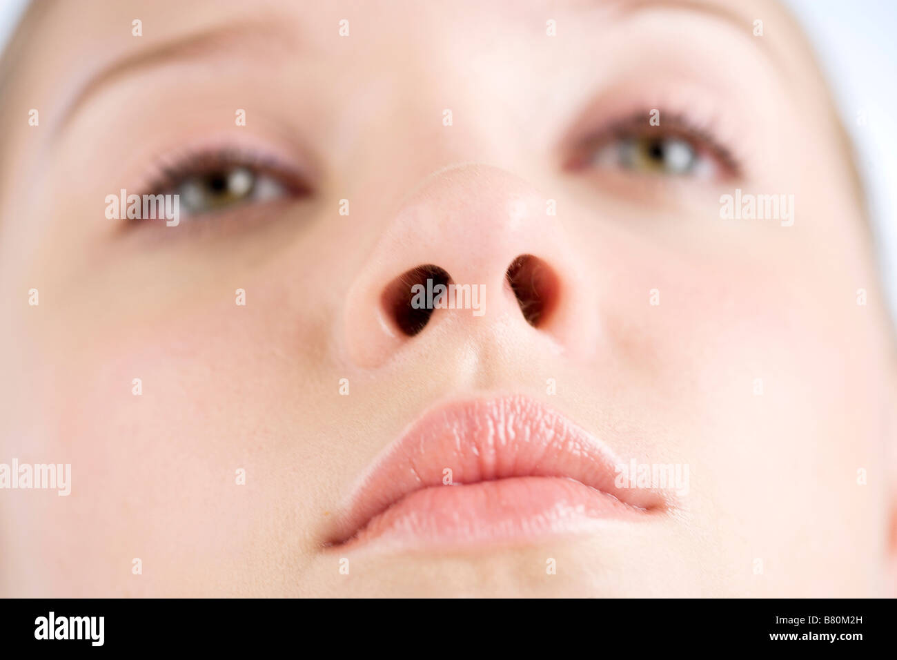 Close up to a young woman s face eyes looking up Stock Photo - Alamy