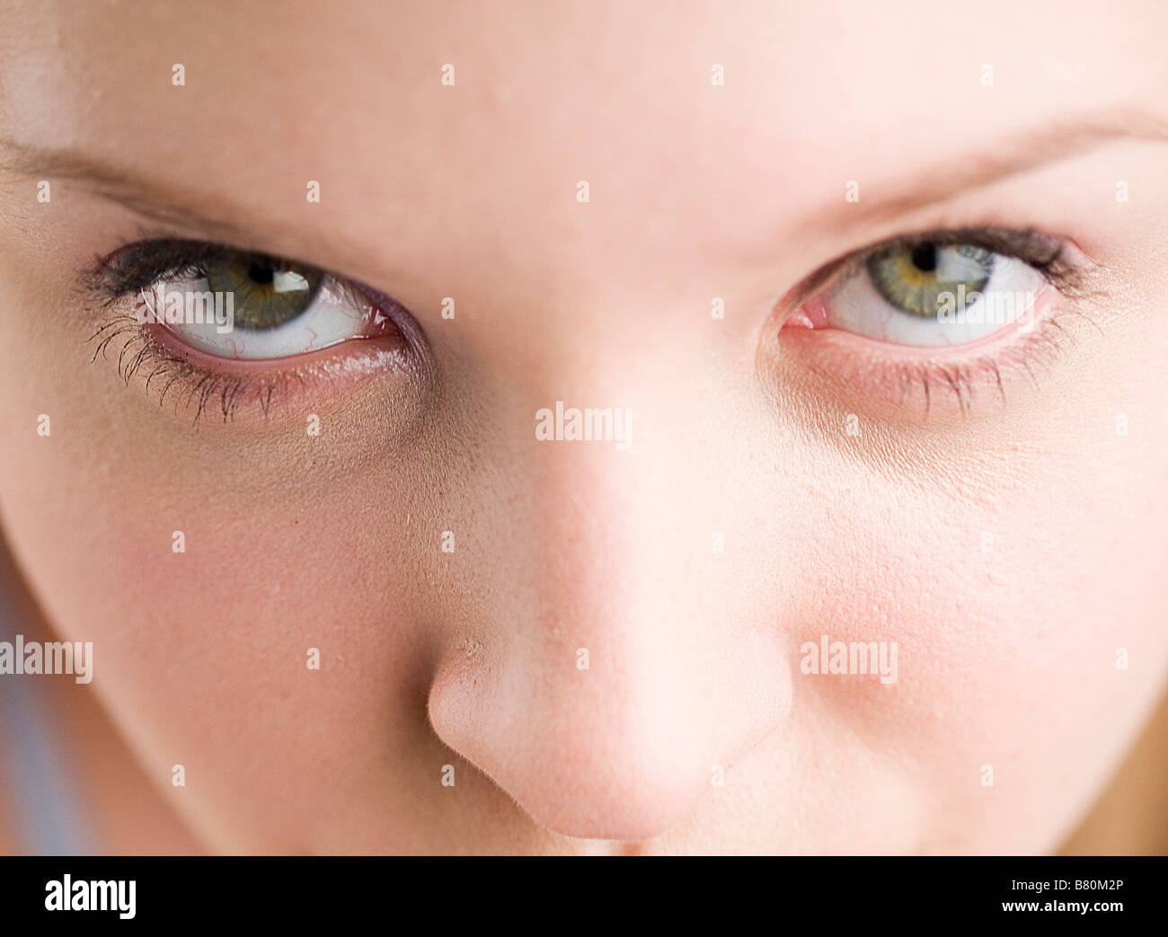 Close up to a young woman s face looking at the camera Stock Photo - Alamy