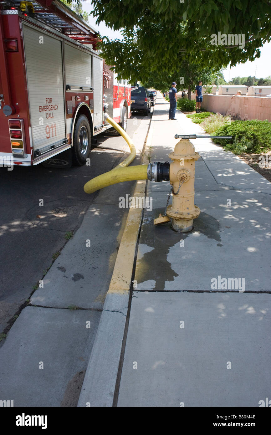 fire truck connected to fire hydrant on a sidewalk, united states Stock ...