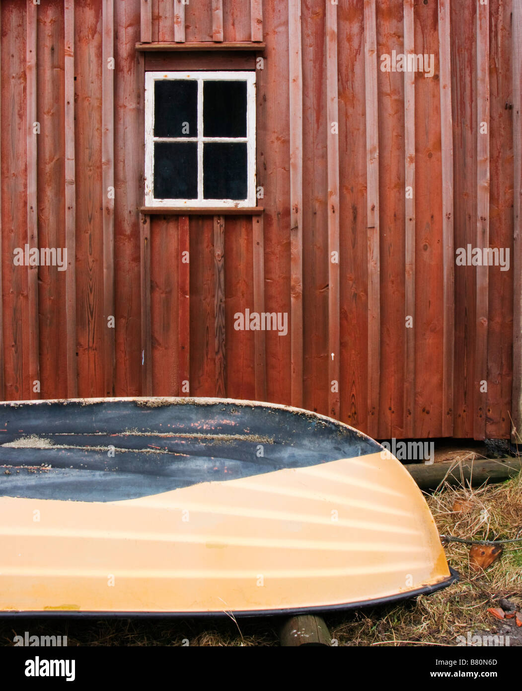 Detail of boat and red painted wooden boathouse in fishing village of ...