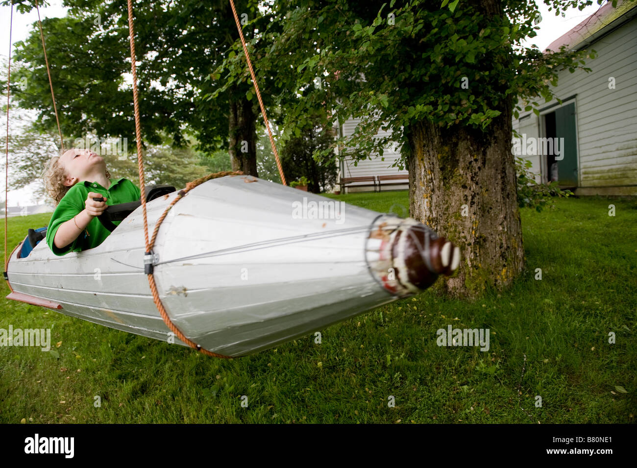 A young boy plays in a swing built as a spaceship Stock Photo - Alamy