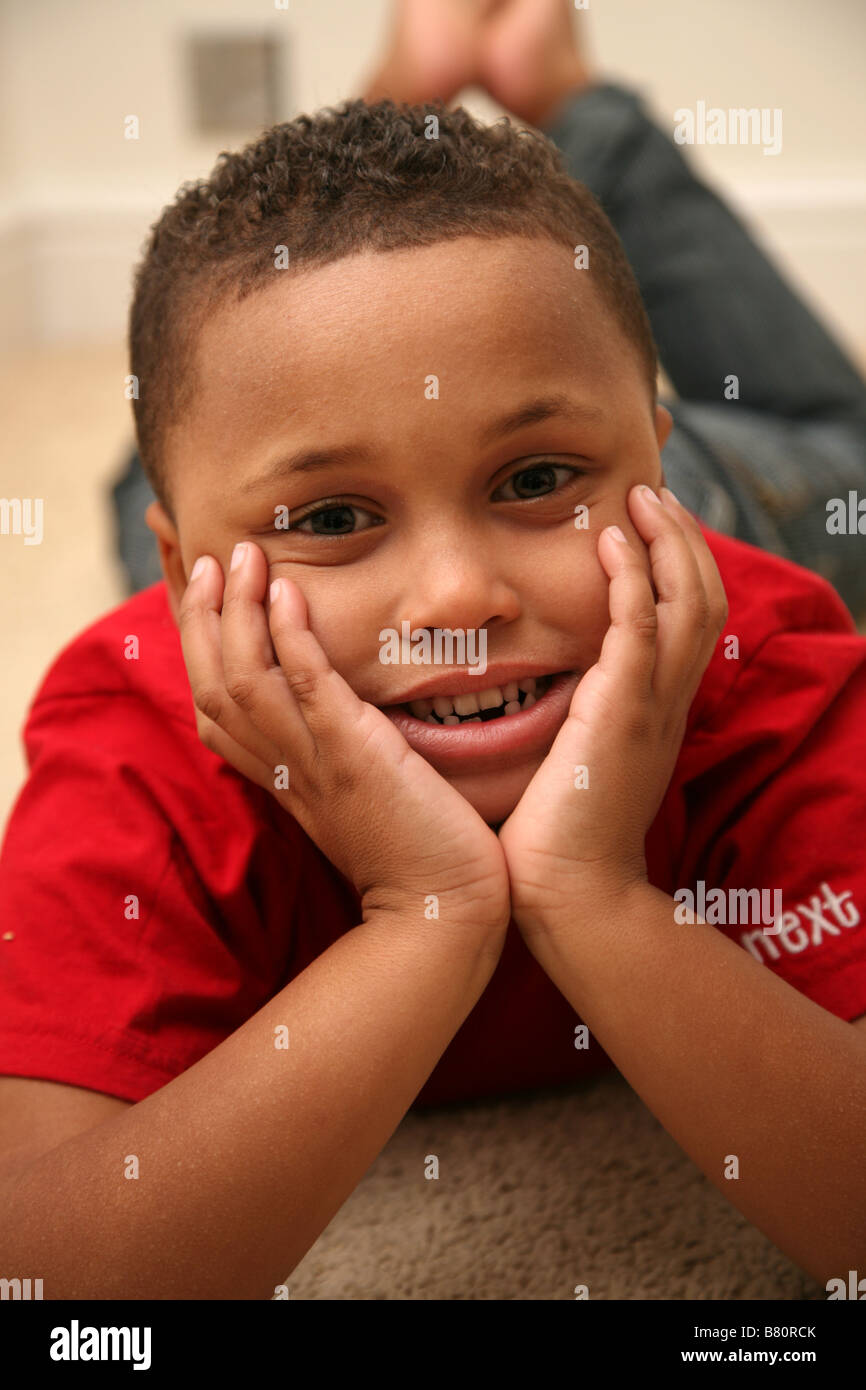 Afro caribbean boy daydreaming Stock Photo - Alamy