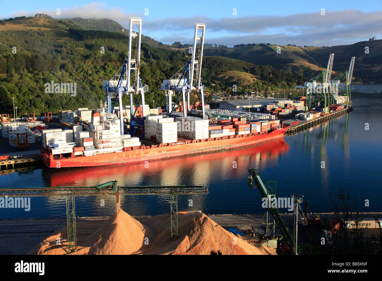 Container ship at terminal in morning sunlight,Port Chalmers, Otago ...