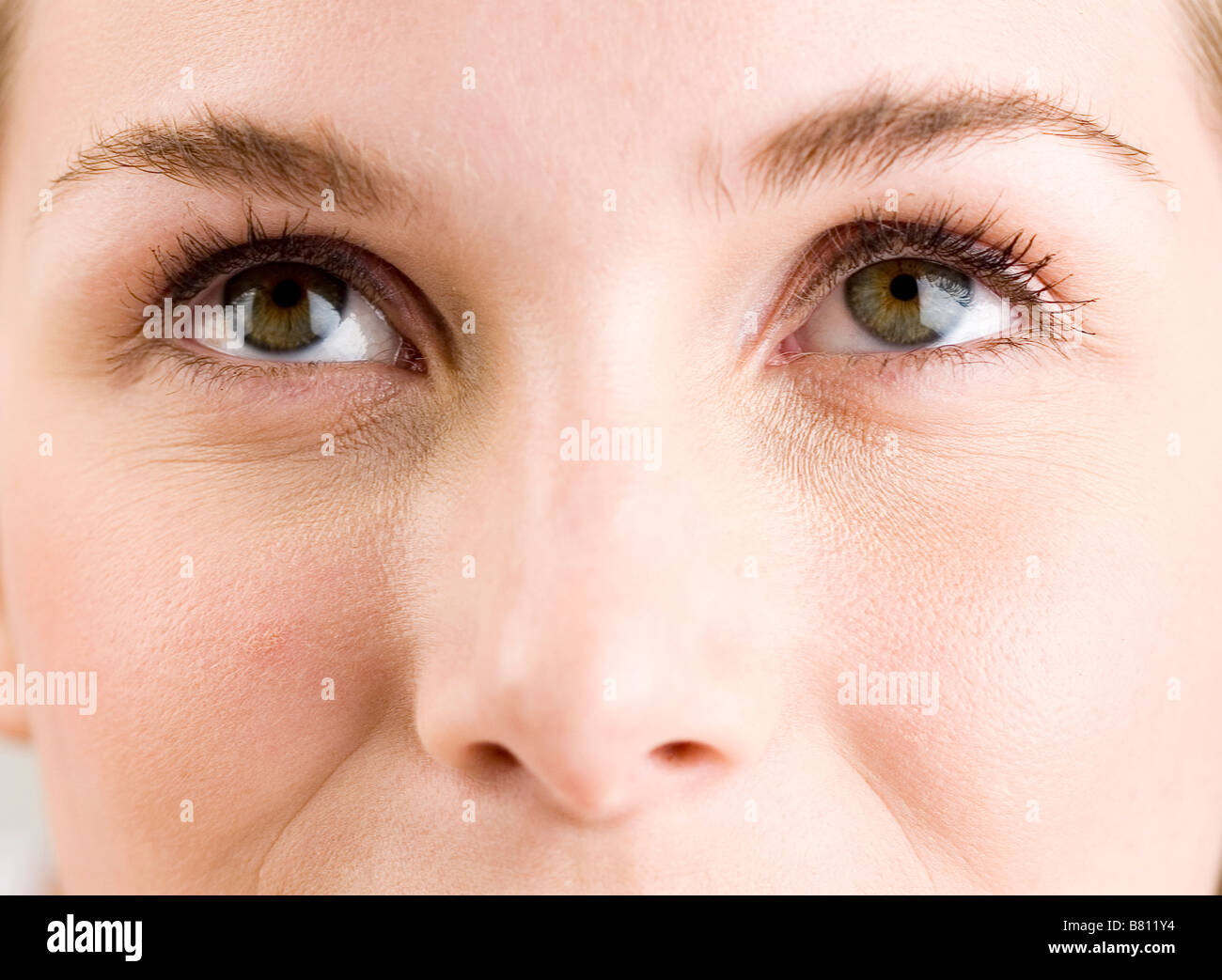 Close up to a young woman s face eyes looking up Stock Photo - Alamy