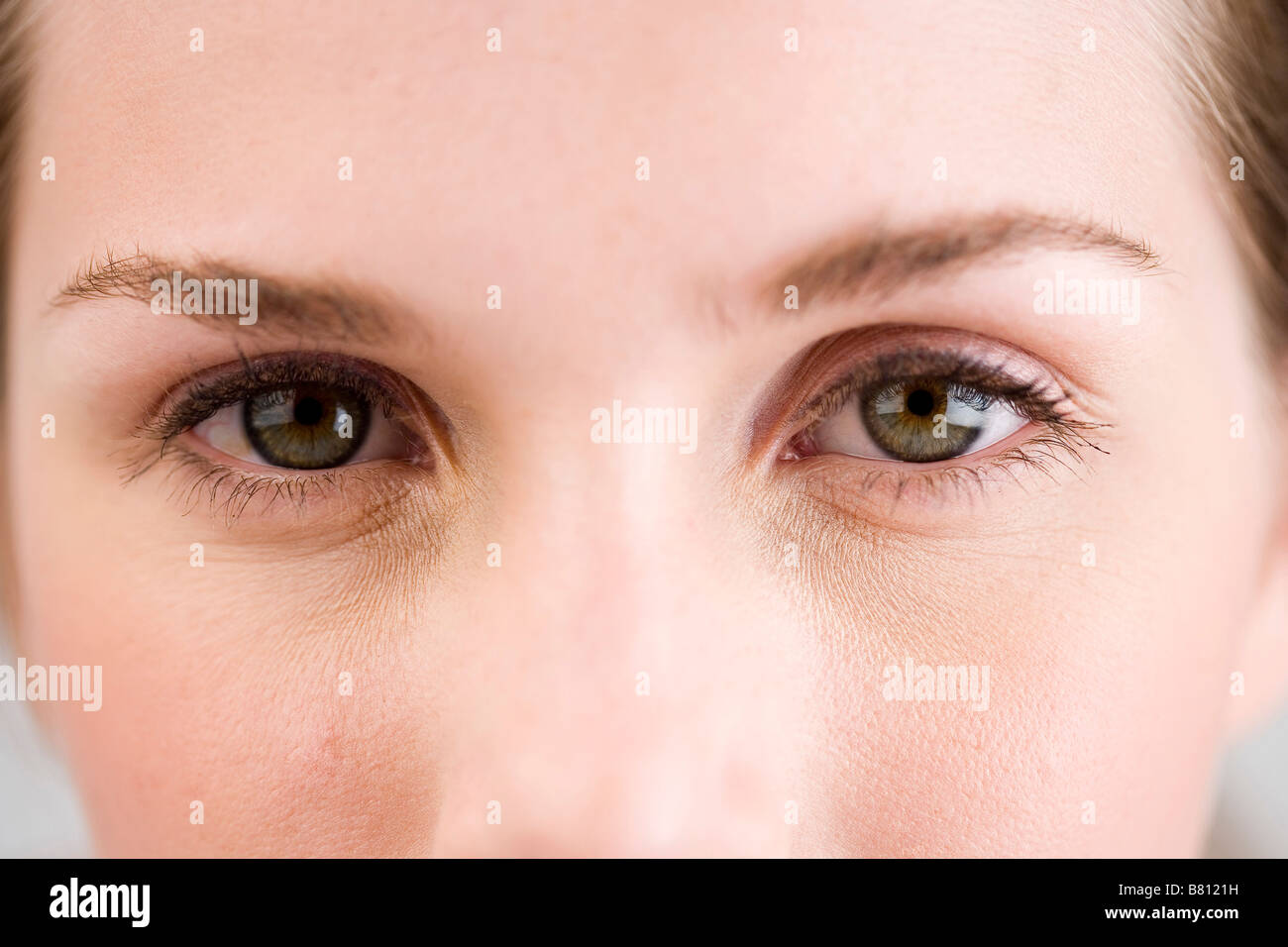 Close up to a young woman s face looking at the camera Stock Photo - Alamy