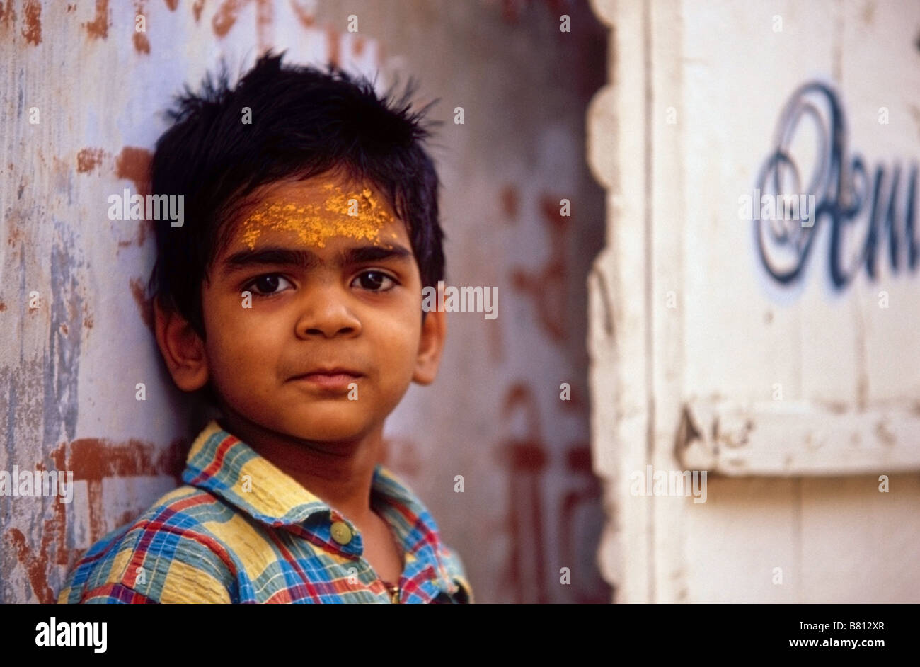 A boy with orange color applied to his forehead Stock Photo - Alamy