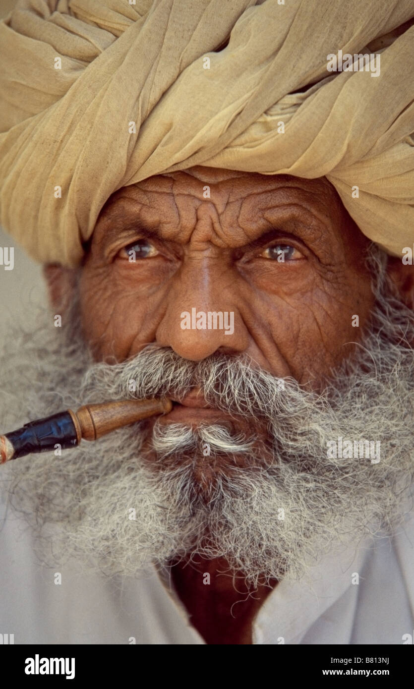 Portrait of a turbaned rajasthani man smoking waterpipe Stock Photo - Alamy