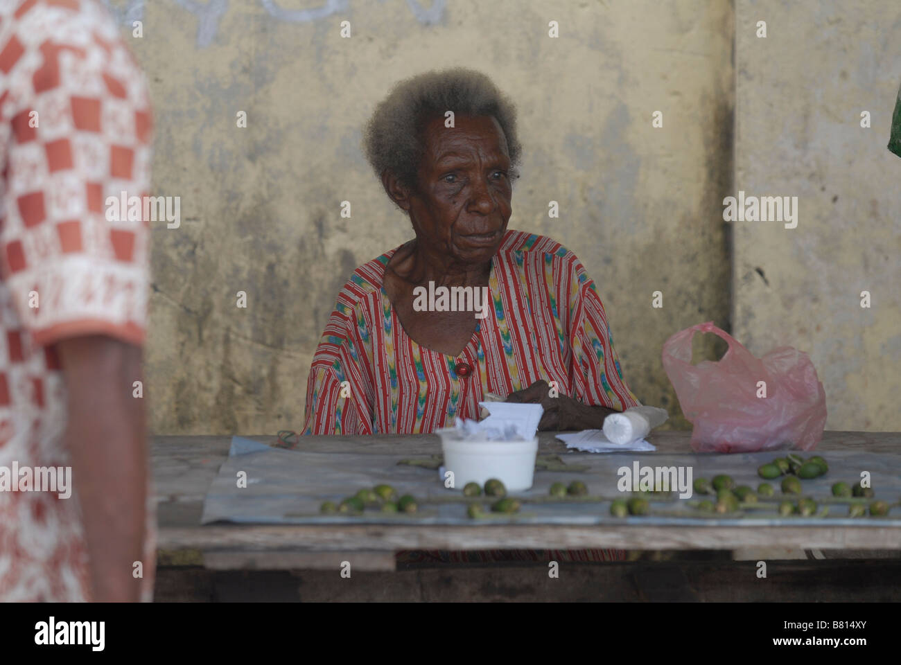 Old and poor woman selling bethelnut at the market of Biak, Indonesia ...