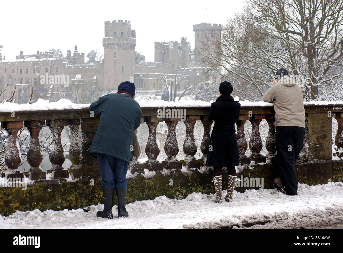 People photographing Warwick Castle in snow from the bridge, Warwick ...