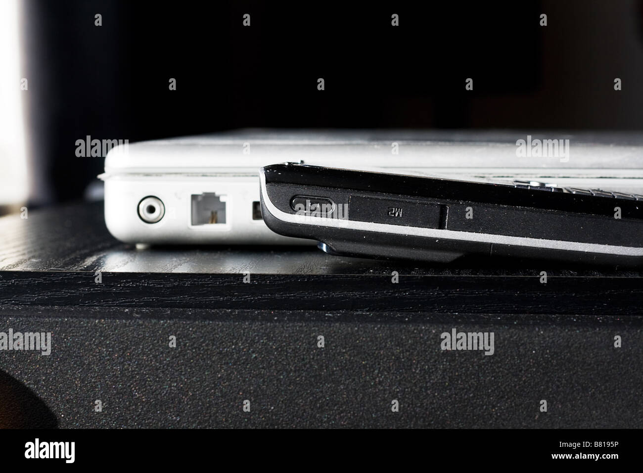 Close up side view of mobile telephone and laptop computer Stock Photo ...