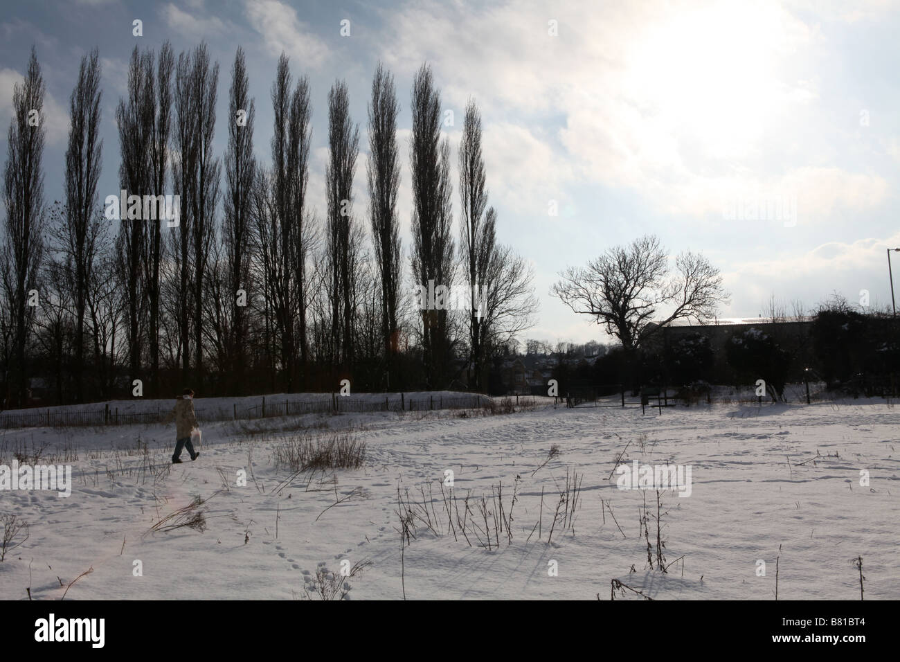 a young boy walks a frozen field after his school had closed due to the ...