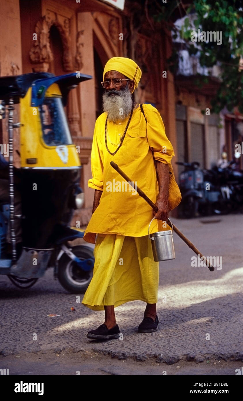 An indian sadhu in a bright yellow dress in the streets od Jaipur Stock ...