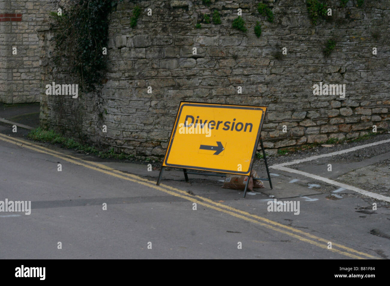 bright yellow and black warning diversion sign Stock Photo - Alamy