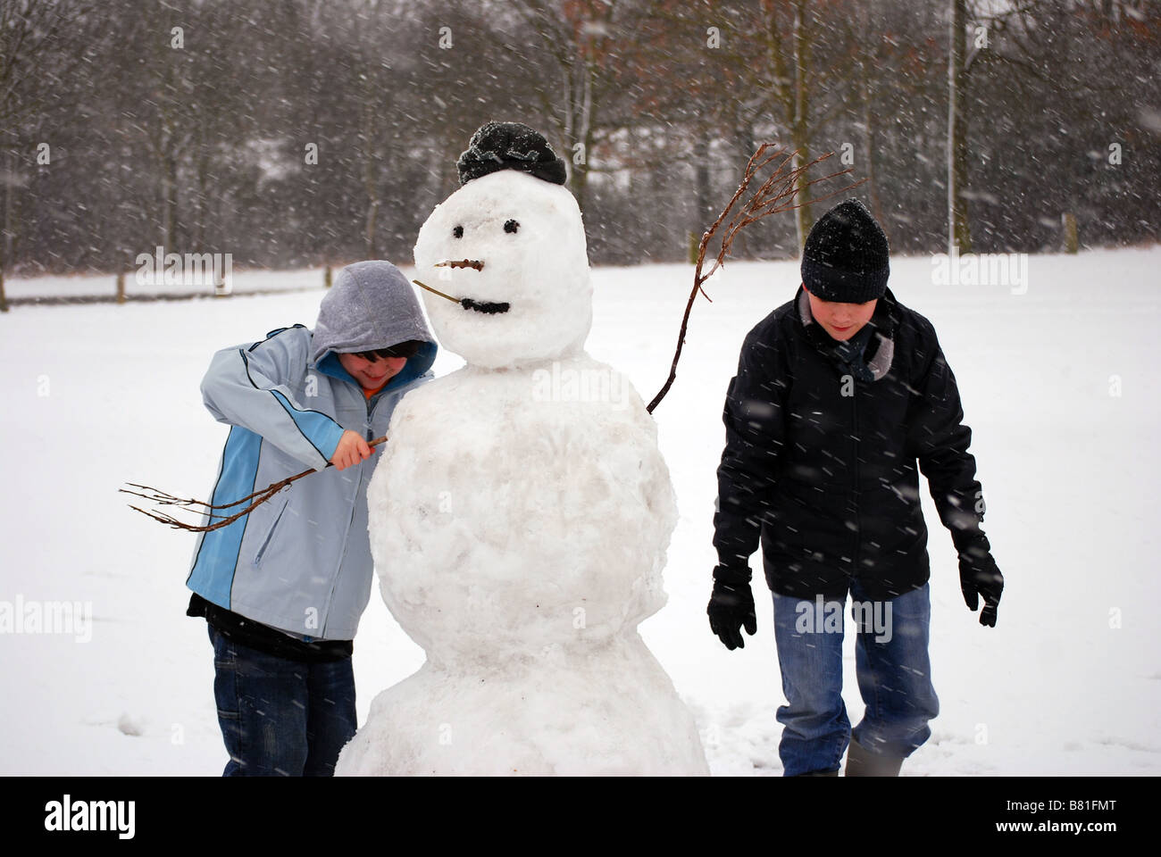 Kids Making a Snowman Stock Photo - Alamy