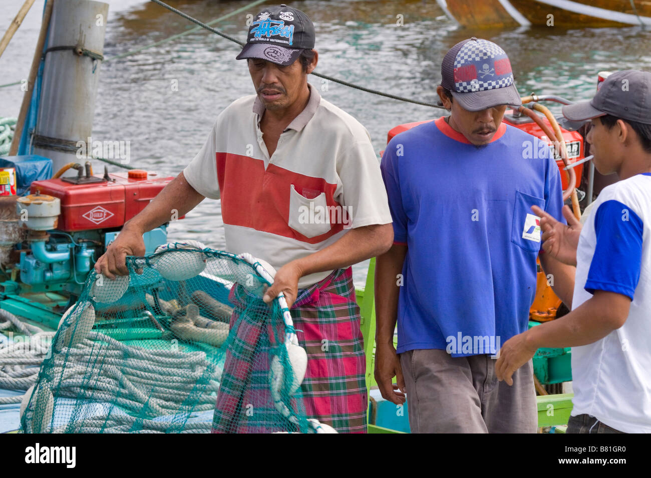 Balinese fishermen loading a net in Pangambengan Bali Indonesia Stock ...
