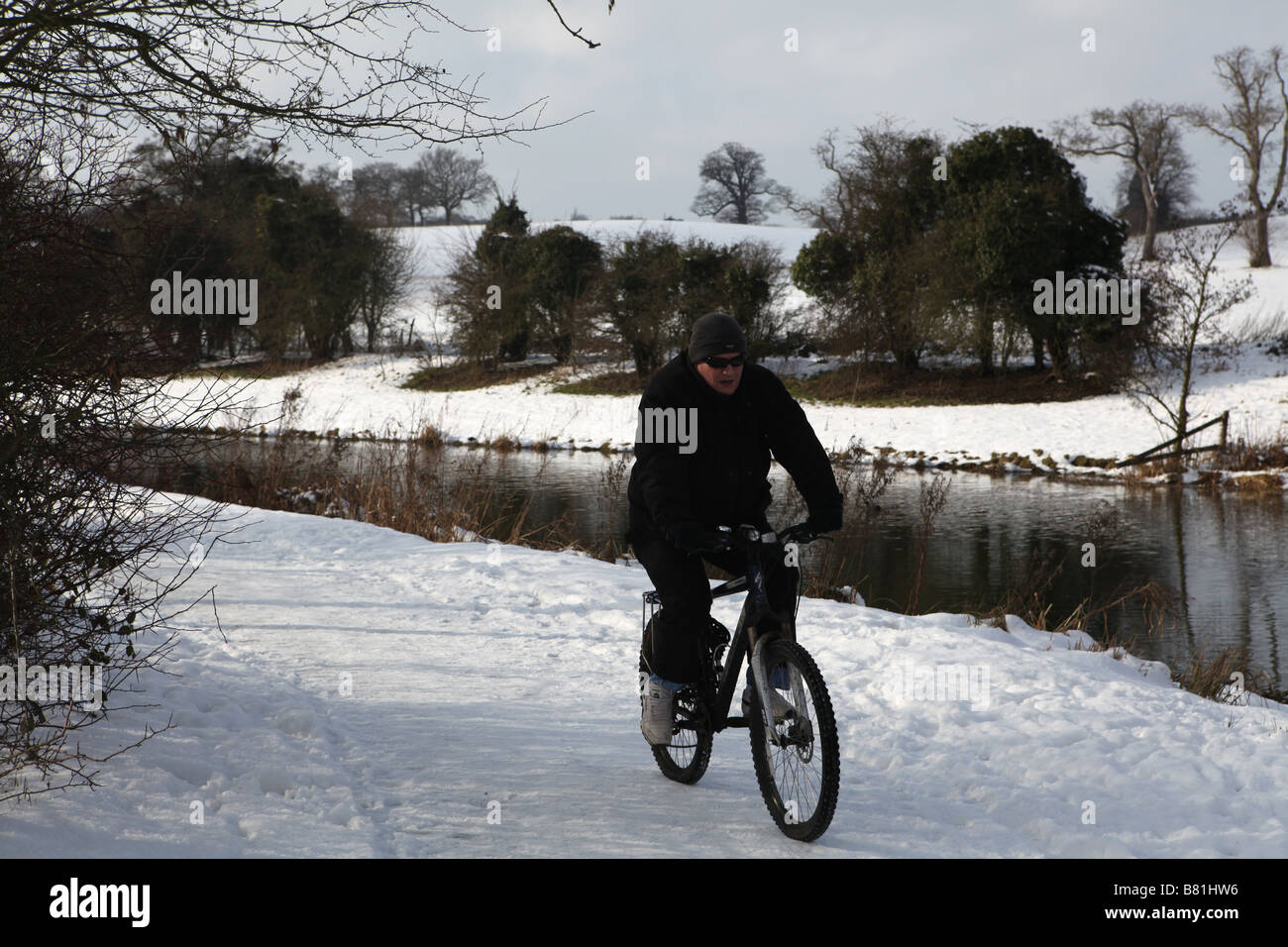 a bike rider braving freezing conditions and rides his bicycle through ...