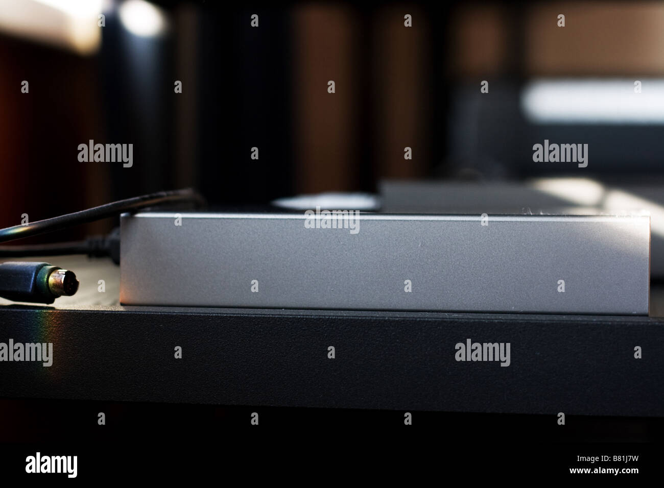 Side view of silver external hard disk with cables on rack shelf Stock ...