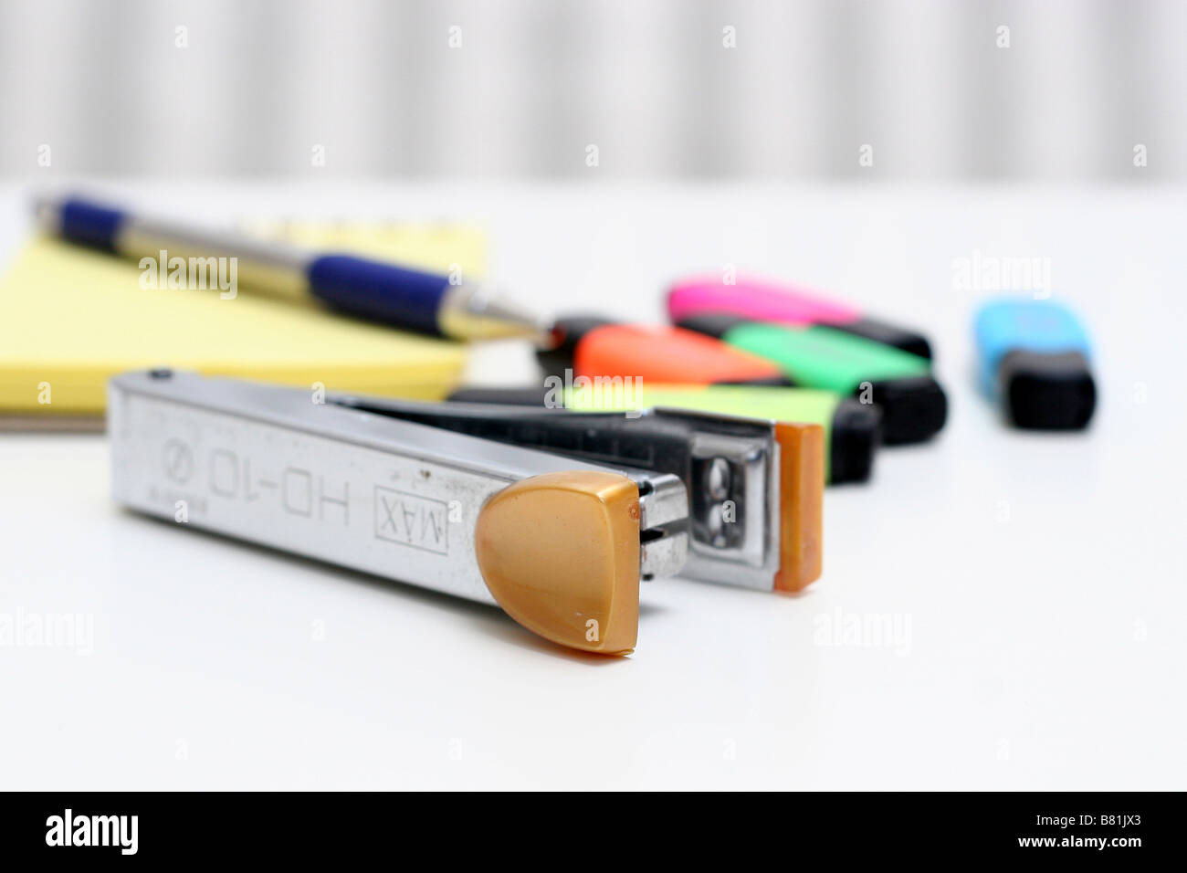 Stapler pens markers and a notepad on white Stock Photo - Alamy
