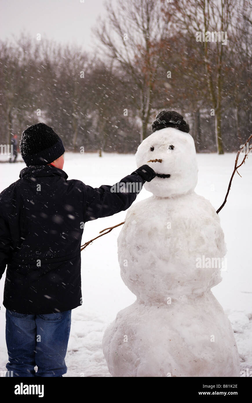 Boy Making a Snowman Stock Photo - Alamy