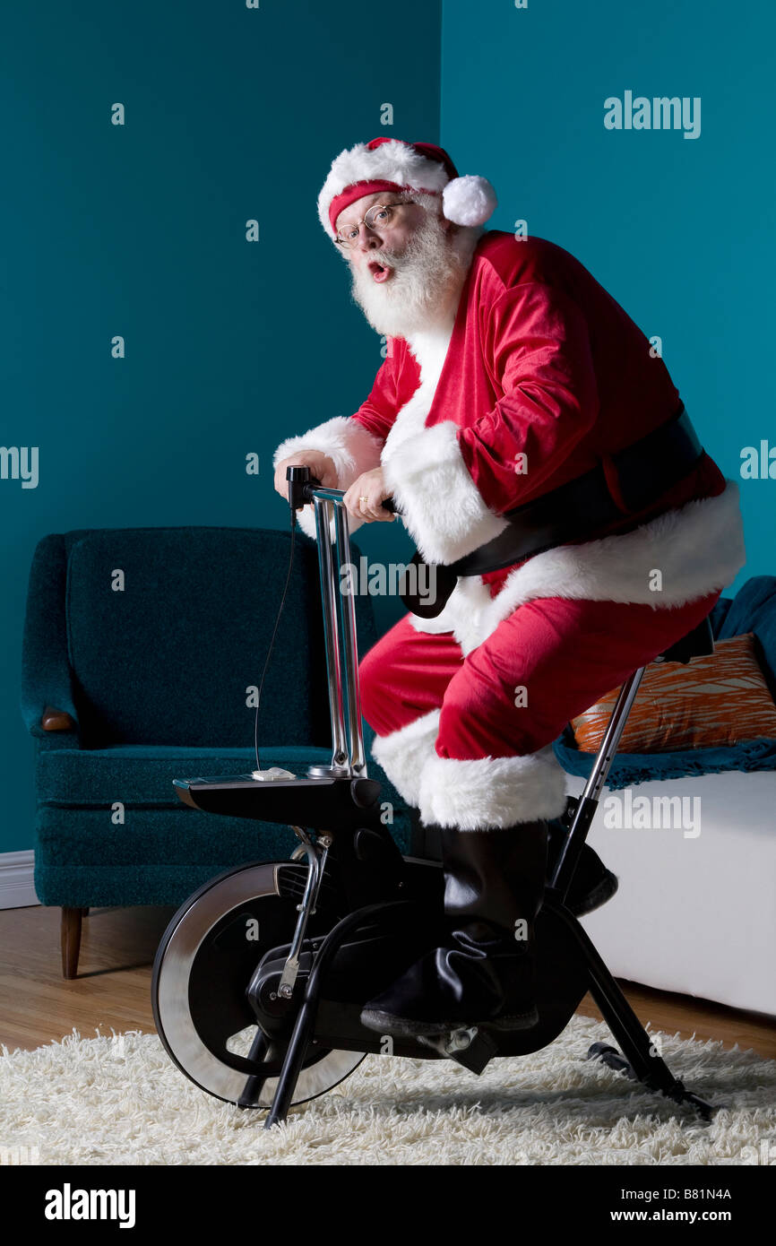 Santa riding stationary bike Stock Photo - Alamy