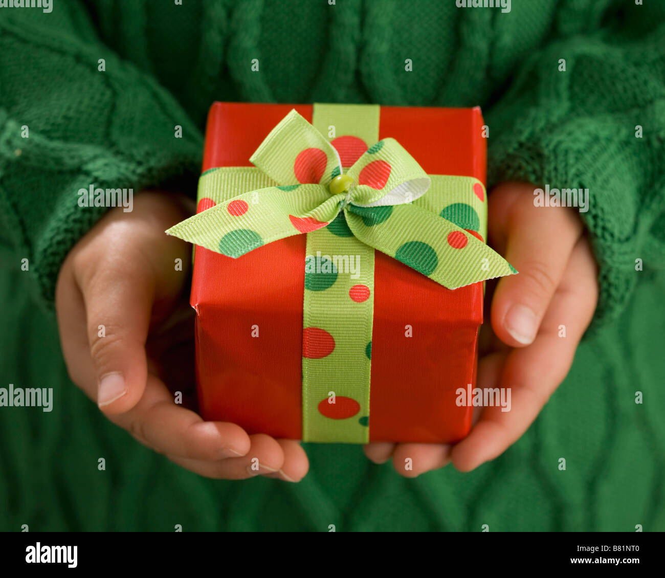 Child's hands holding a present Stock Photo - Alamy